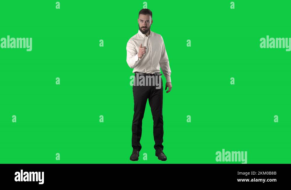 Angry business man or teacher scolding finger and shaking head on green ...