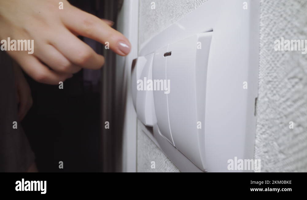 Woman turns off light touching switch installed on wall Stock Video ...