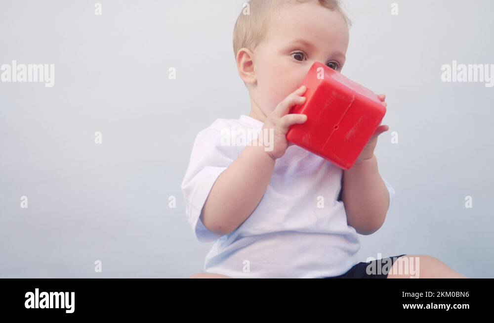 baby drooling bubbles on the lips a toddler play with a cube at home ...