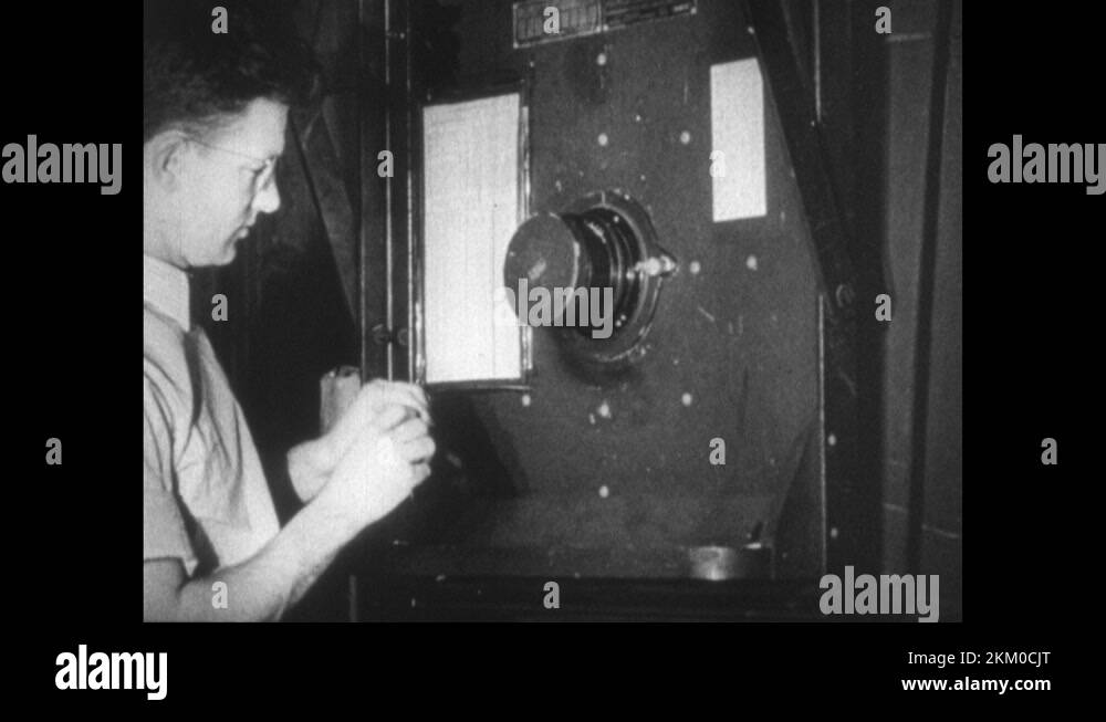 1940s: Man removes plate from behind camera. Man replaces filter behind ...