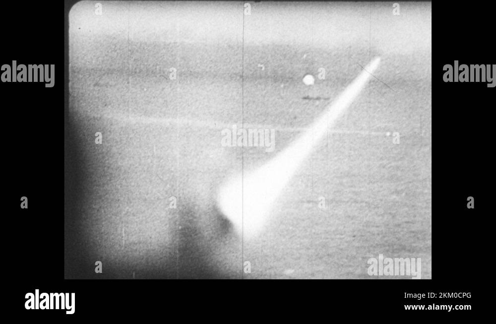 1940s: Aerial shot from plane turret, gun firing on ship. Gunner in ...