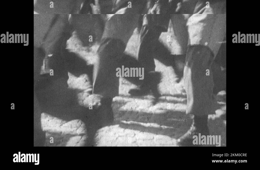 1930s: Tracking shot, soldiers marching. Feet marching. Rear view ...