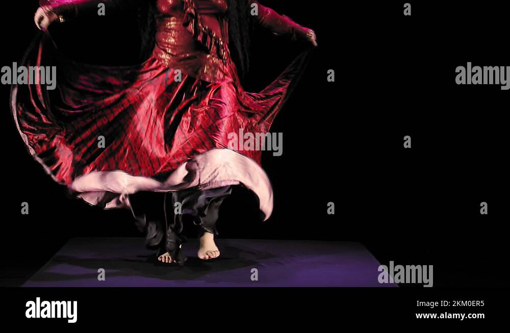 A barefoot gypsy woman without a face with long black hair in a red ...