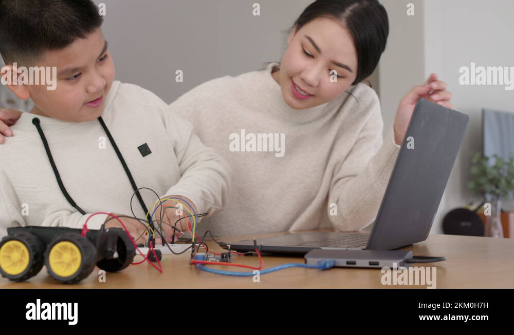 Asian parent teach kid learn coding toy stem car at home Stock Video ...