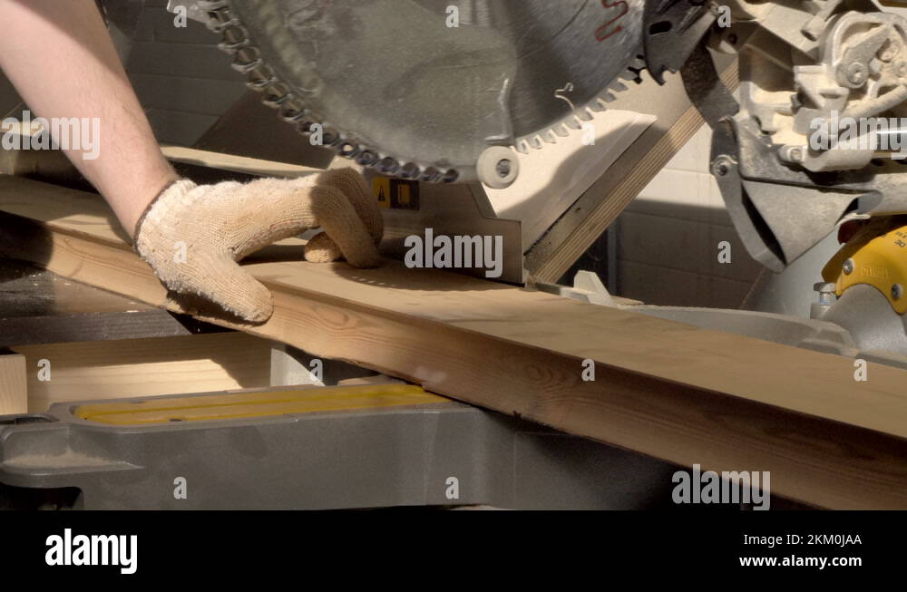 Thermo Pine plank cut with industrial circular saw. Creating a cloud of ...