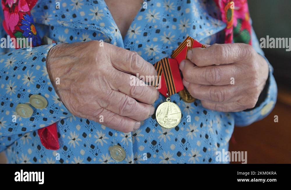 Old lady veteran with medals. Soviet union awards. Celebrating may of 9 ...