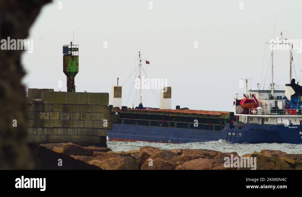 Large blue cargo ship leaving Port of Liepaja (Latvia) trough stone ...