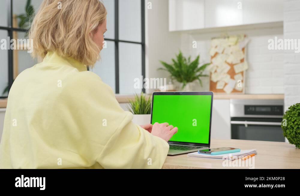 Girl uses green screen chroma key laptop for learning, writes down ...