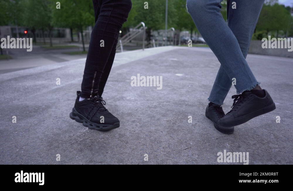Legs, feet of two people dancing a choreography outdoors, slow motion ...