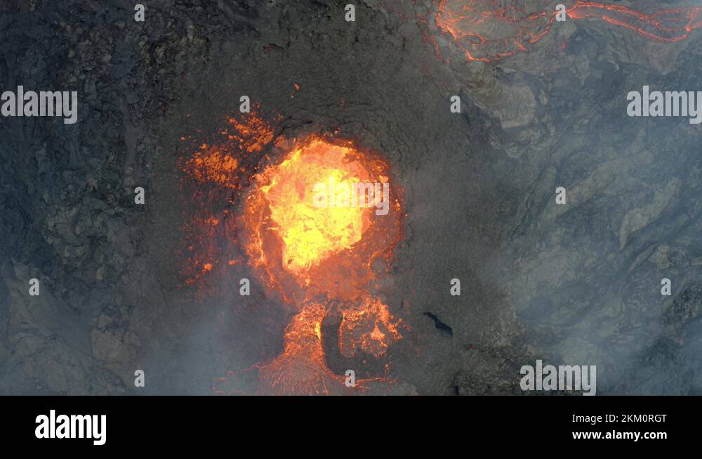Drone vertically over active, hot and continuous volcanic eruption ...
