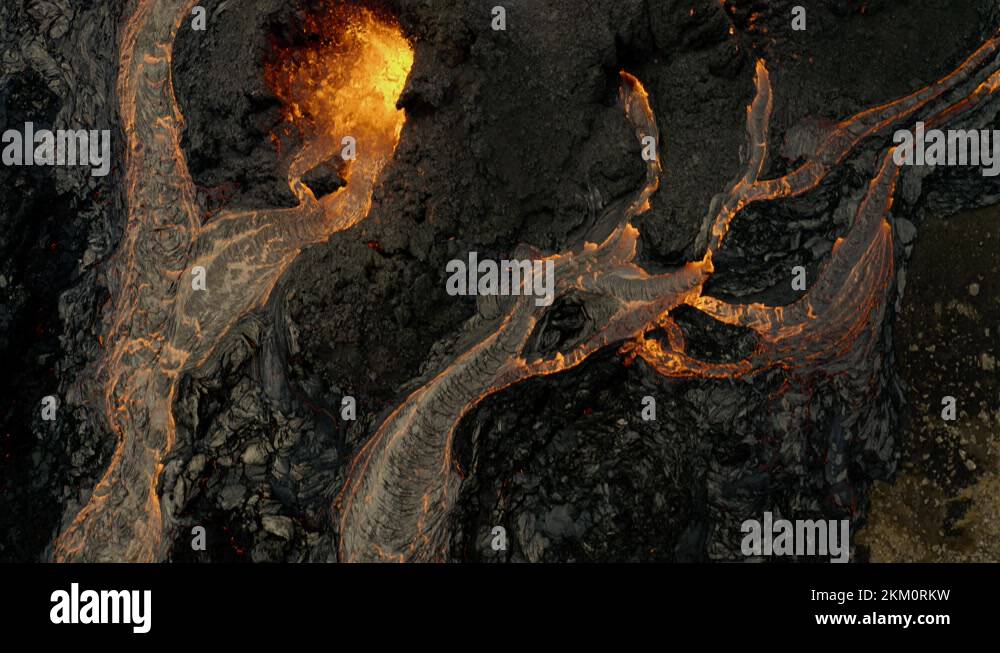 Drone flying over streams of fresh flowing lava erupting from two ...