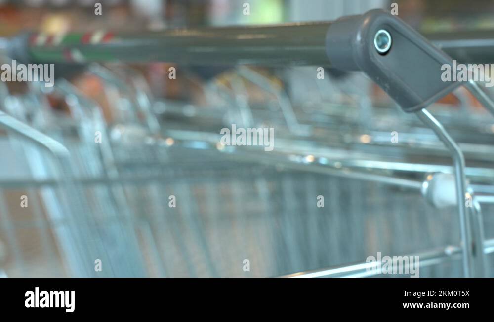 The customer takes a trolley from the row Stock Video Footage - Alamy