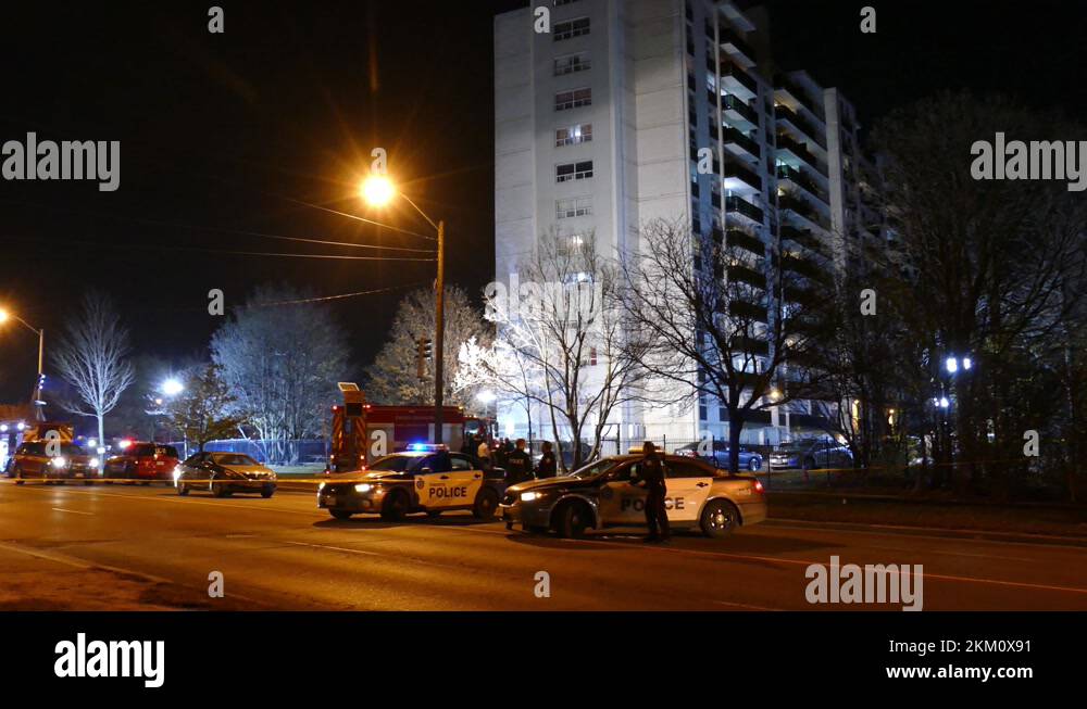 Accident area Police car warning lights low angle overview pan left ...