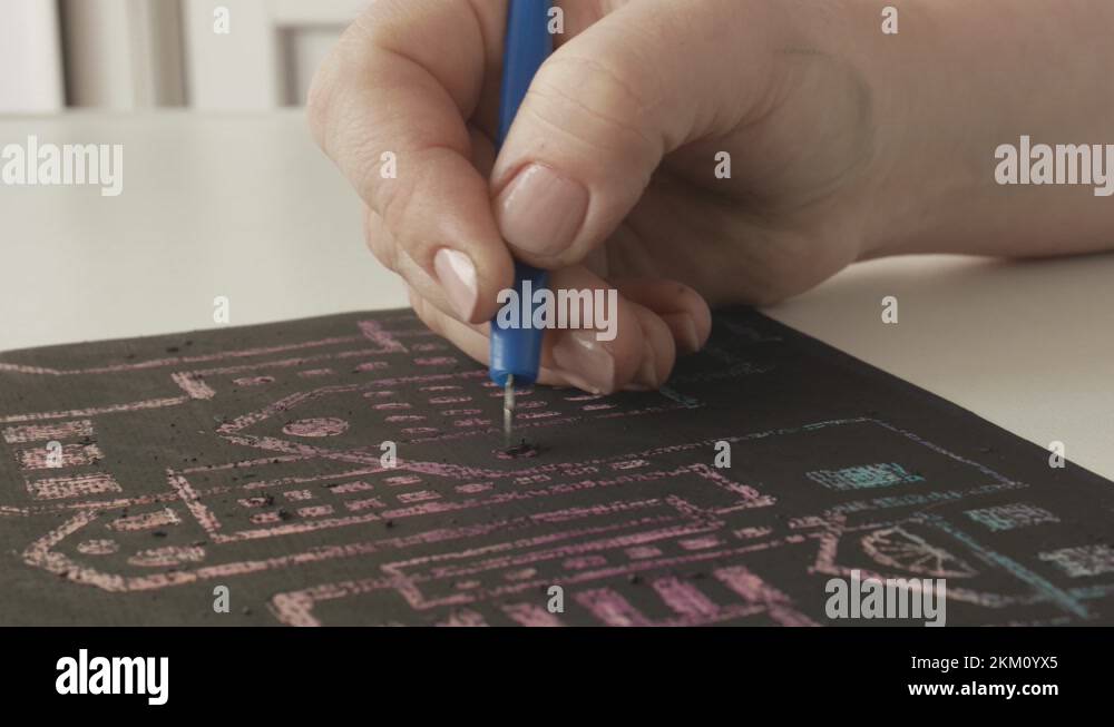 Engraving. Drawing process. Scratching with a pen on a chemoy ...