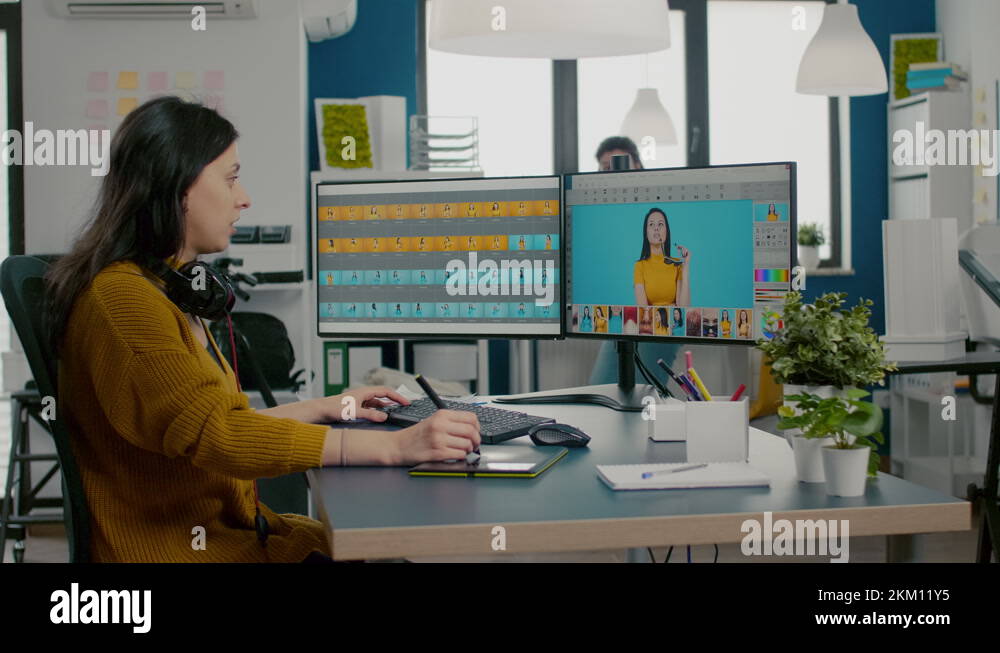 Woman graphic editor retouching photos of client in professional app ...