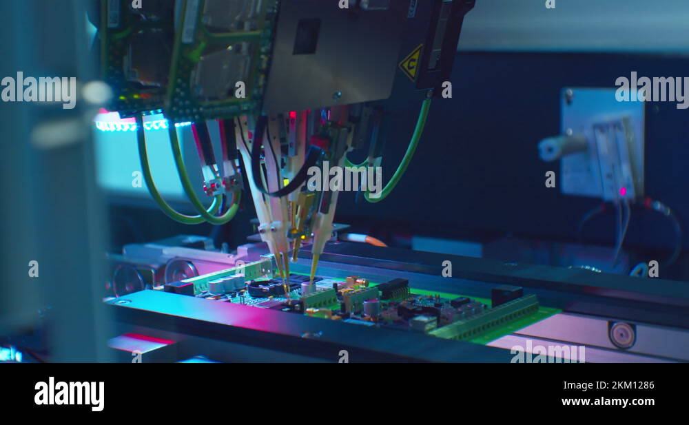 Industrial robot for electronics manufacturing makes a complex printed ...