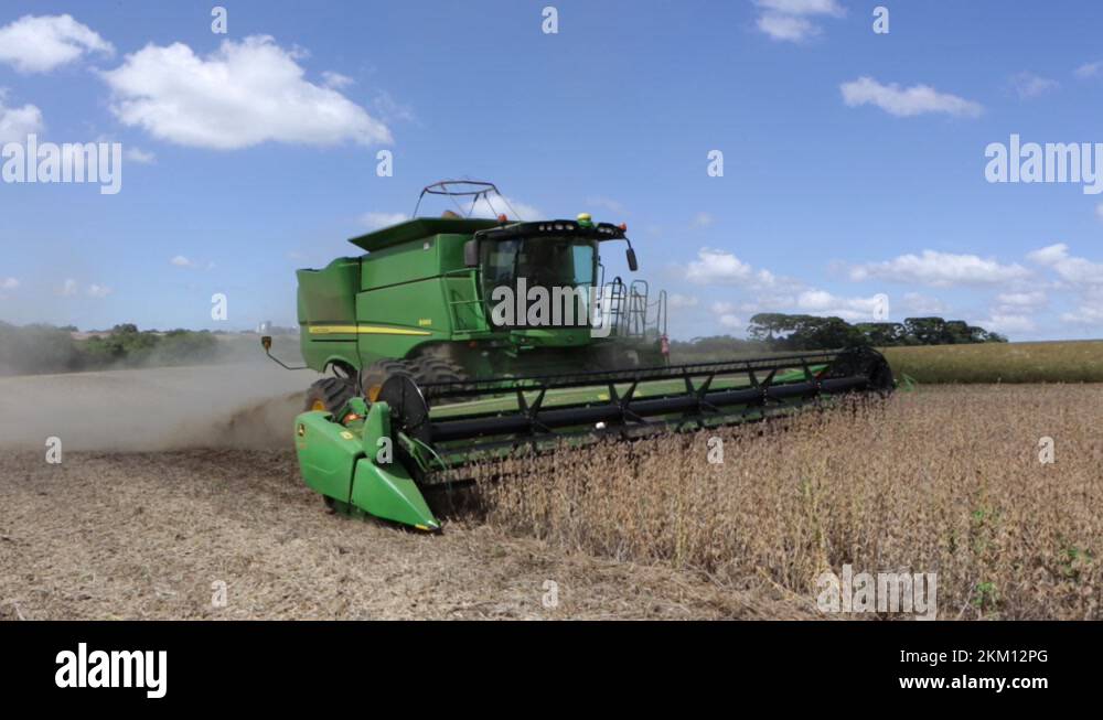 Modern soybean harvester harvesting soybeans in a farm field. John ...