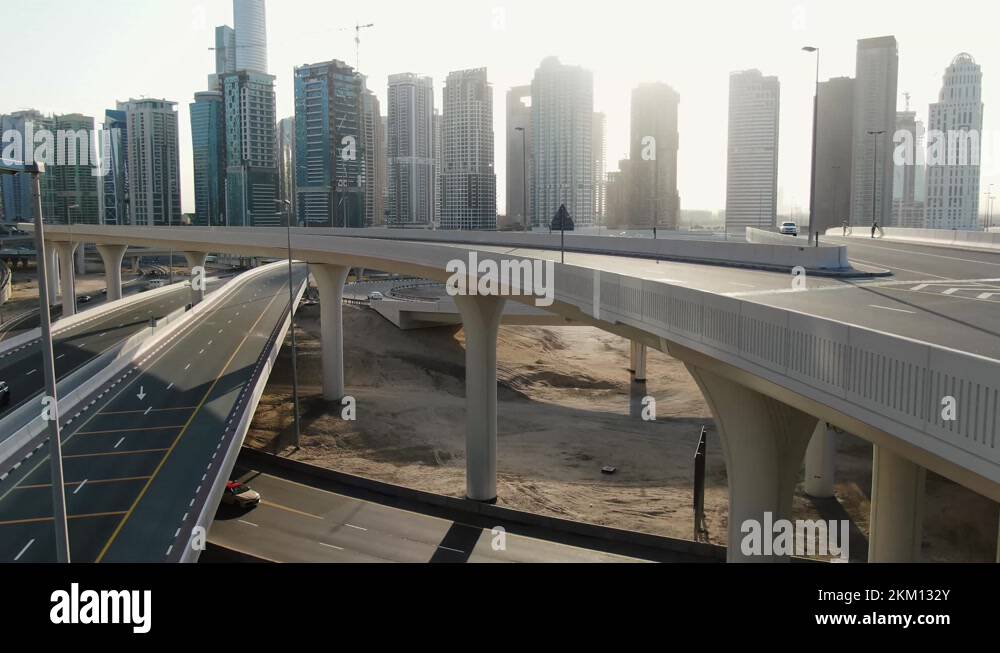 Dubai city with its many skyscrapers and a big multi level intersection ...