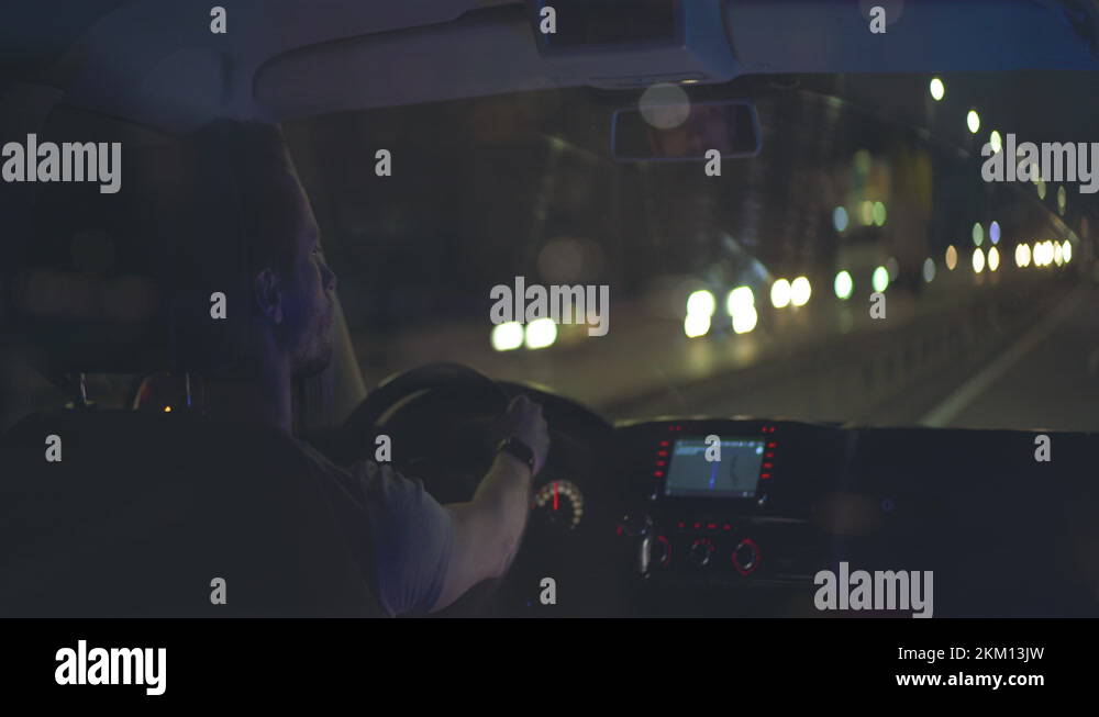 Man drive car in the city at night. Anamorphic lens shot Stock Video ...