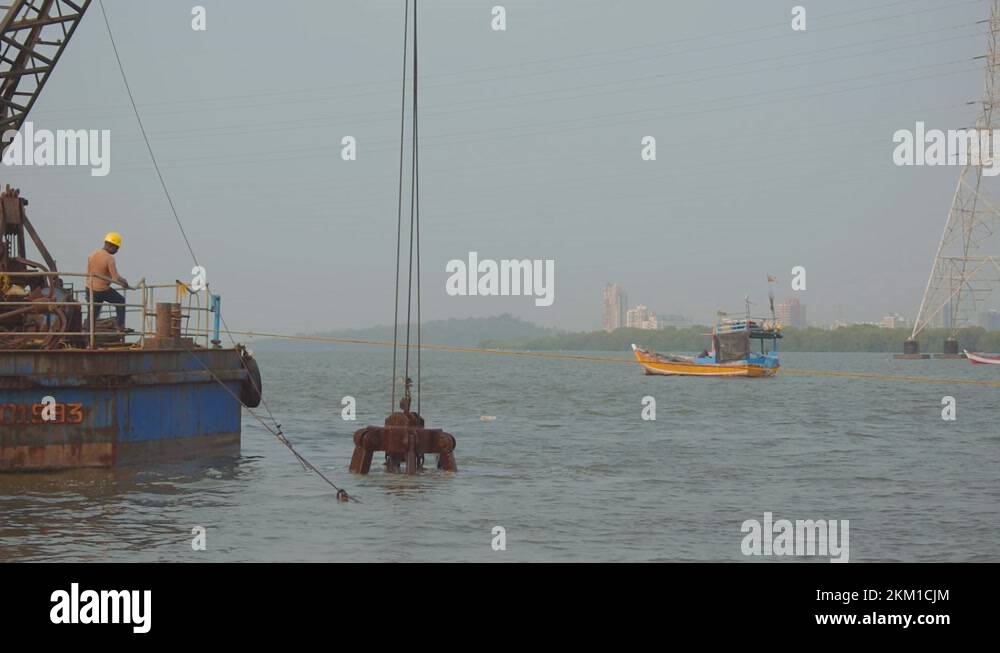 Mining or cleaning trash from bay or Ocean with a big ship crane digger ...
