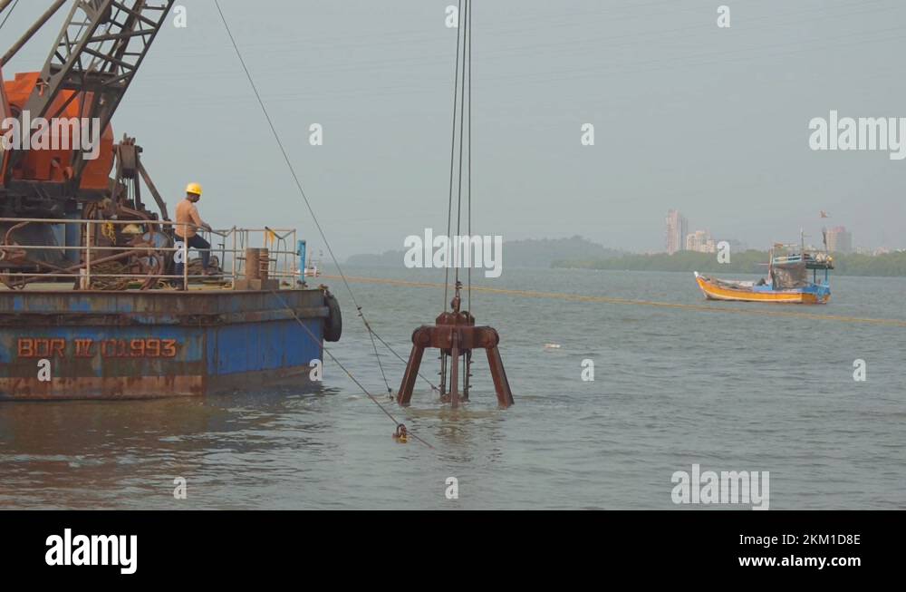Mining or cleaning trash from bay or Ocean with a big ship crane digger ...