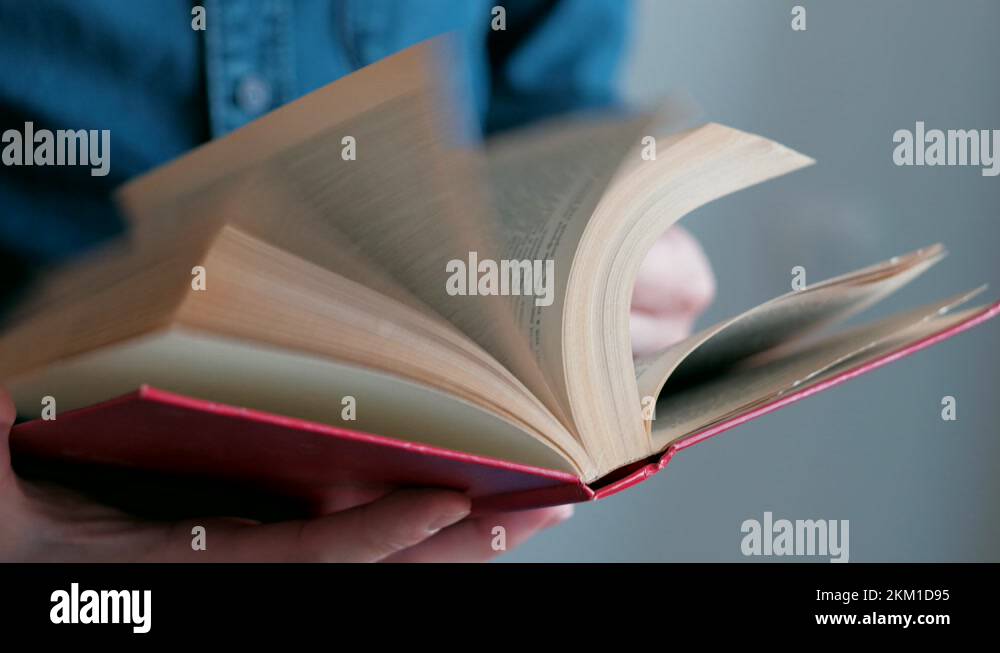 Close-up - Pages of the book are flipped. Looped. Man flips pages the ...