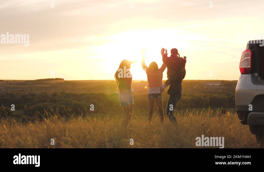 Mom and children stopped by car to rest, camping. Mother and daughters ...
