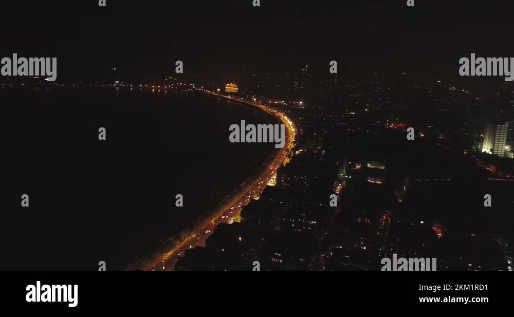 An aerial view with cinematic drone movement of the iconic Marine Drive ...