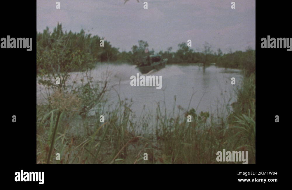1960s: U.S. patrol boat goes down river in Vietnam. Boat on river ...