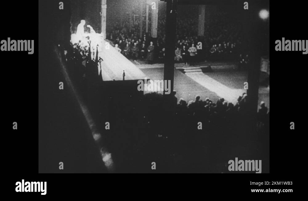 1930s: Adolf Hitler gives speech at podium. Nazi flags. Swastika on ...