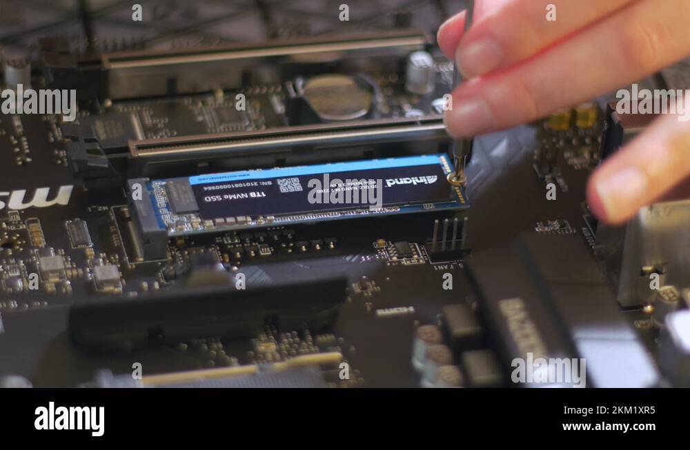 Installing an M.2 SSD Drive onto a Motherboard for a Gaming PC Stock ...