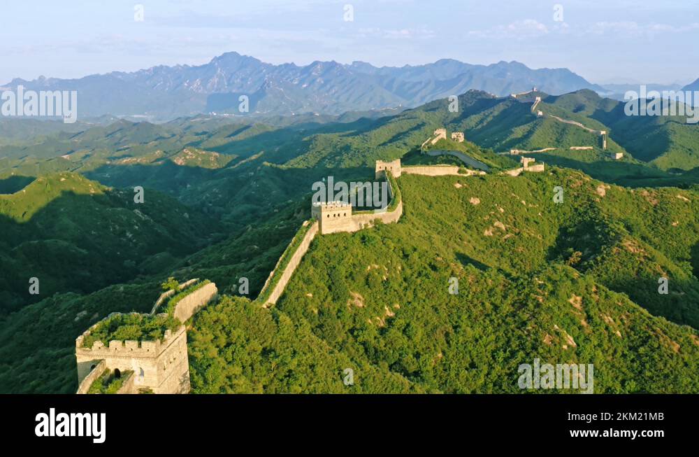 Bird's eye view of Great Wall of China and surrounding green mountains ...