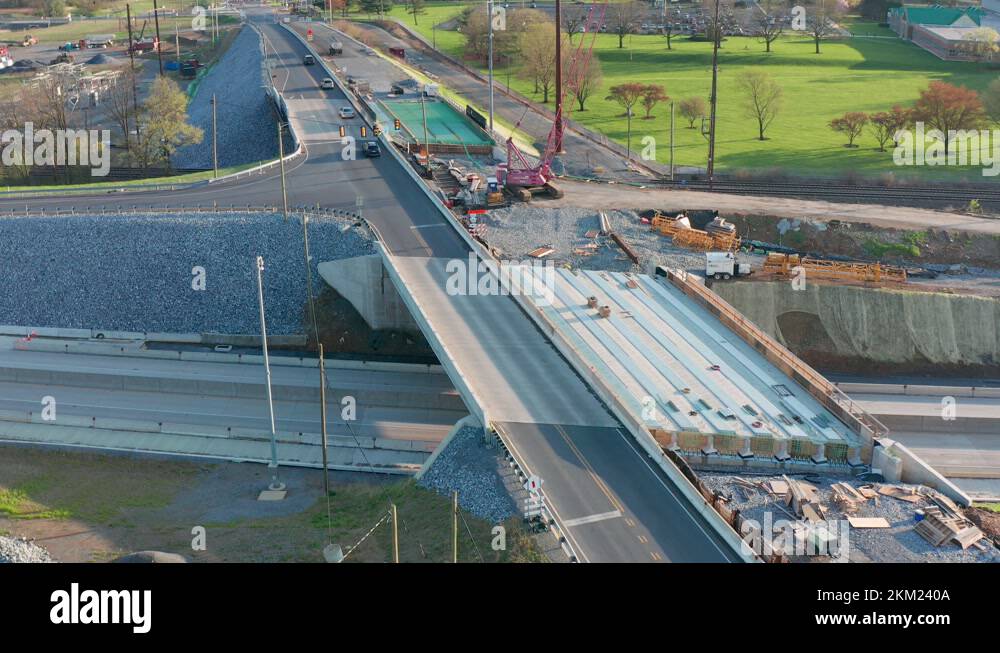 Tilt up aerial reveals bridge and road replacement. Overpass above ...