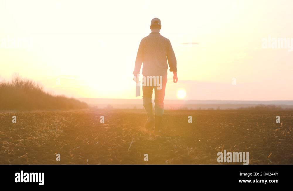 agriculture. smart farming technology. farmer walk feet in boots with ...