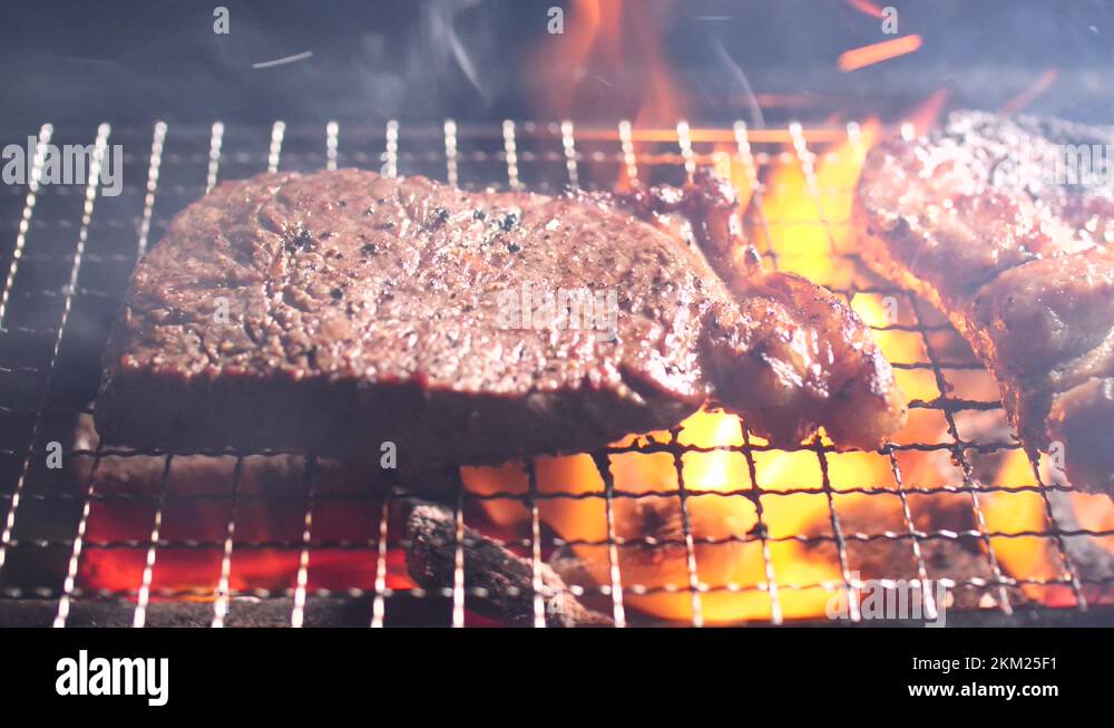 Sirloin grilled steak is on fire 4K. Flame grilled beef steak Stock ...