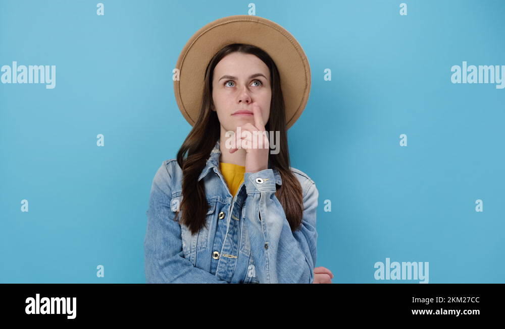 Confused young female put hand prop up on chin spreading arms say oops ...