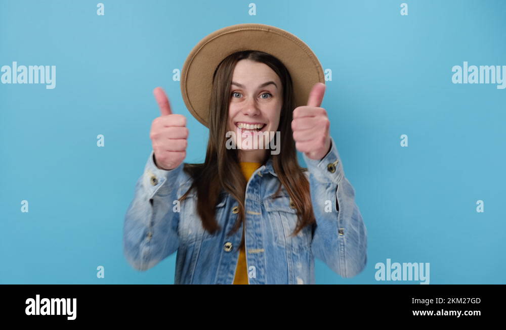 Back rear view young female turn around camera showing thumbs up like ...