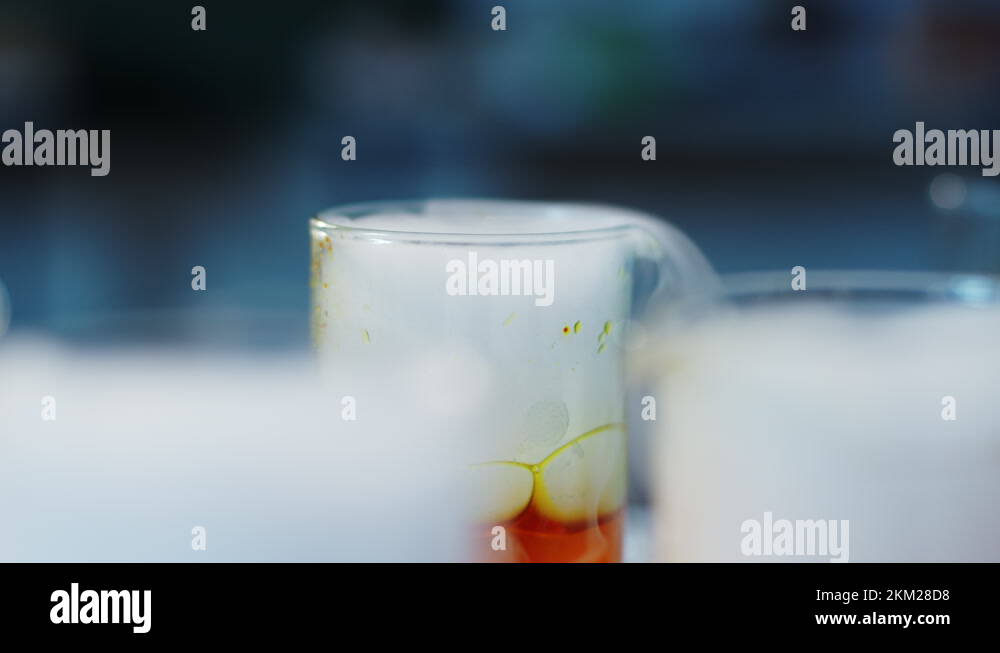 Chemistry laboratory details closeup taking video of a boiling chemical ...