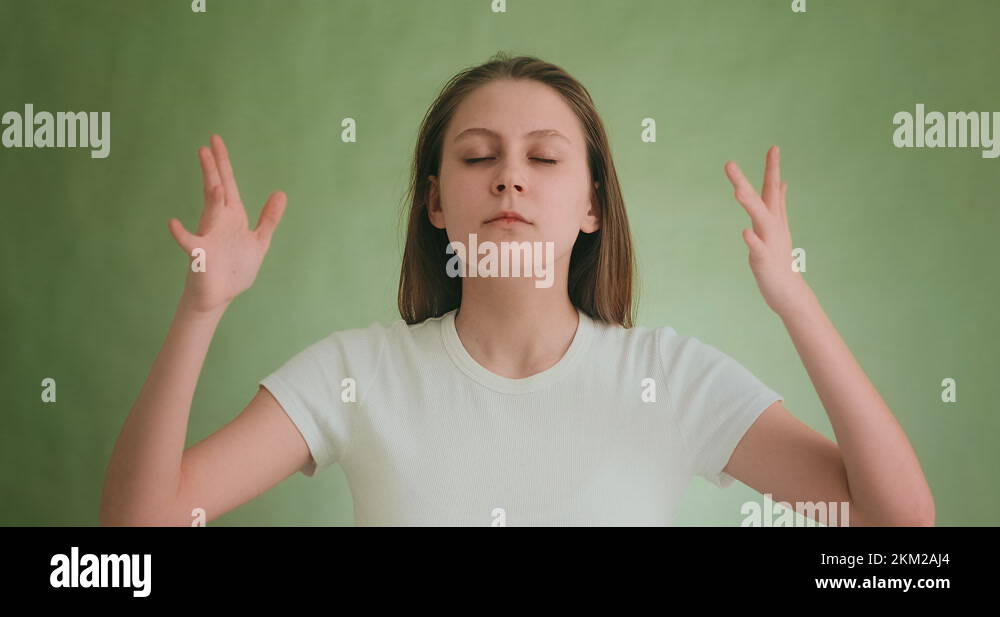 Young woman breathes making gestures to calm down on green Stock Video ...
