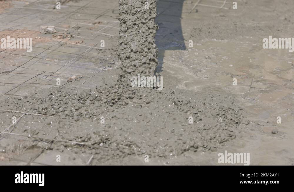 Concrete flowing and pouring from mixer cement truck pours liquid ...