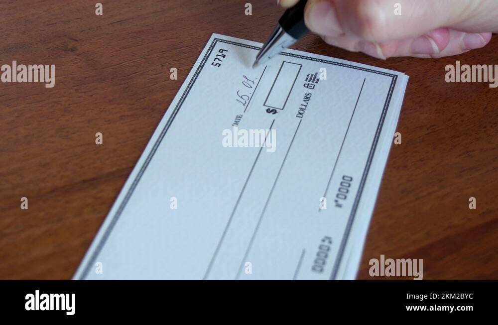 Writing a cheque for payment Stock Video Footage - Alamy