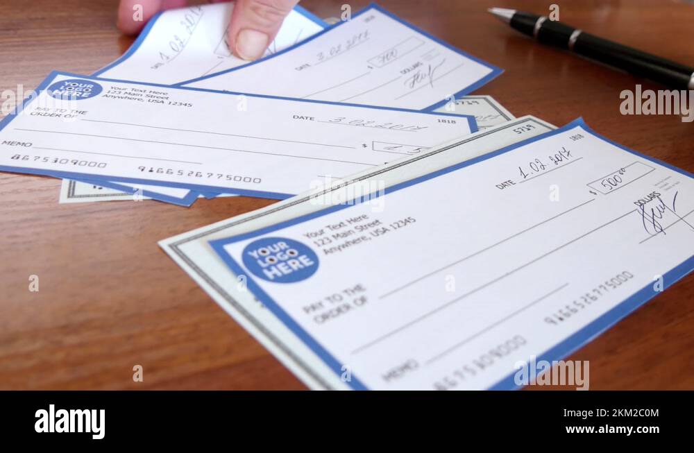 Writing a cheque for payment Stock Video Footage - Alamy