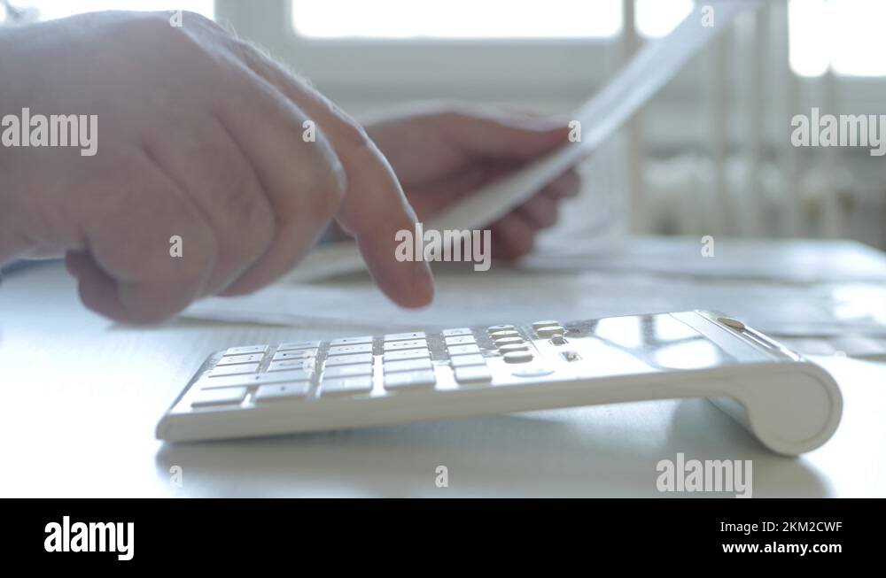 Businessman Makes Calculations Using Adding Machine, Checking Payments ...