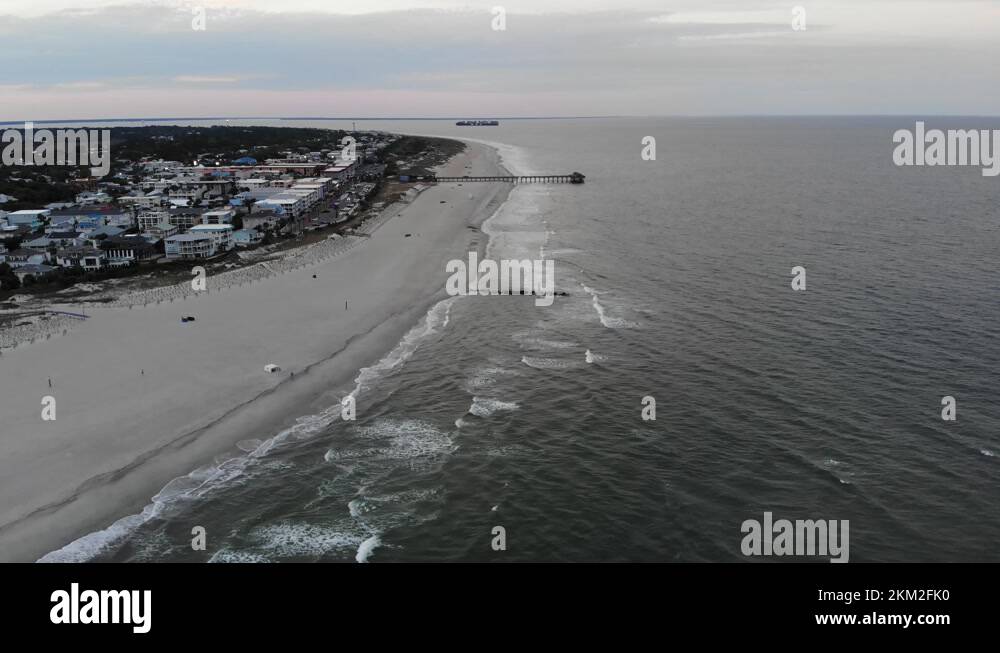 tybee island beach pier container ship sunset ocean jetty aerial drone ...