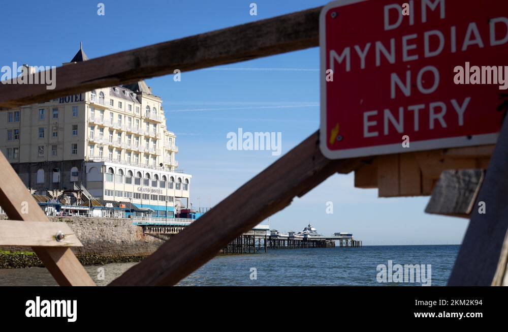 Grand hotel Llandudno pier view through Welsh closed no entry sign on ...