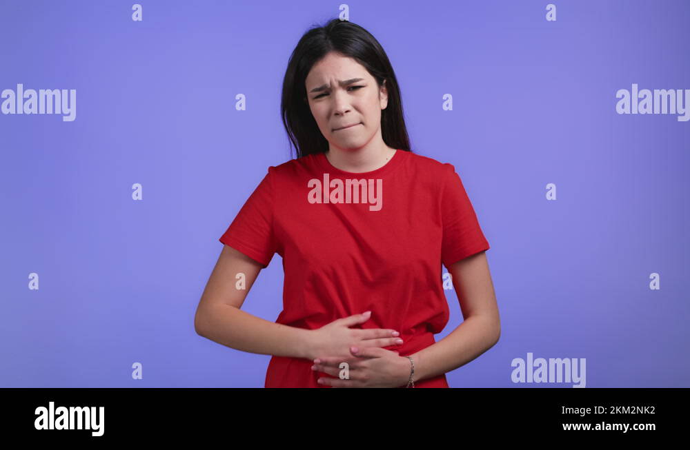 Woman squeezing belly with hands because of abdominal pain. Lady ...