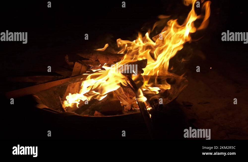 camera slow zoom in on camp fire flames with black background shot in ...