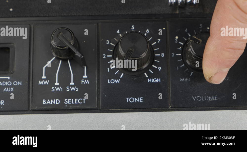 Male hand rotates the volume control knob. Old, retro receiver Stock ...