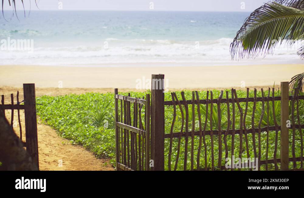 Gate Opening to Pathway onto Beach in Hikkaduwa Stock Video Footage - Alamy