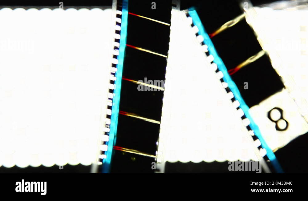 Close up 35mm vintage film strip spool reel moving with numbered ...